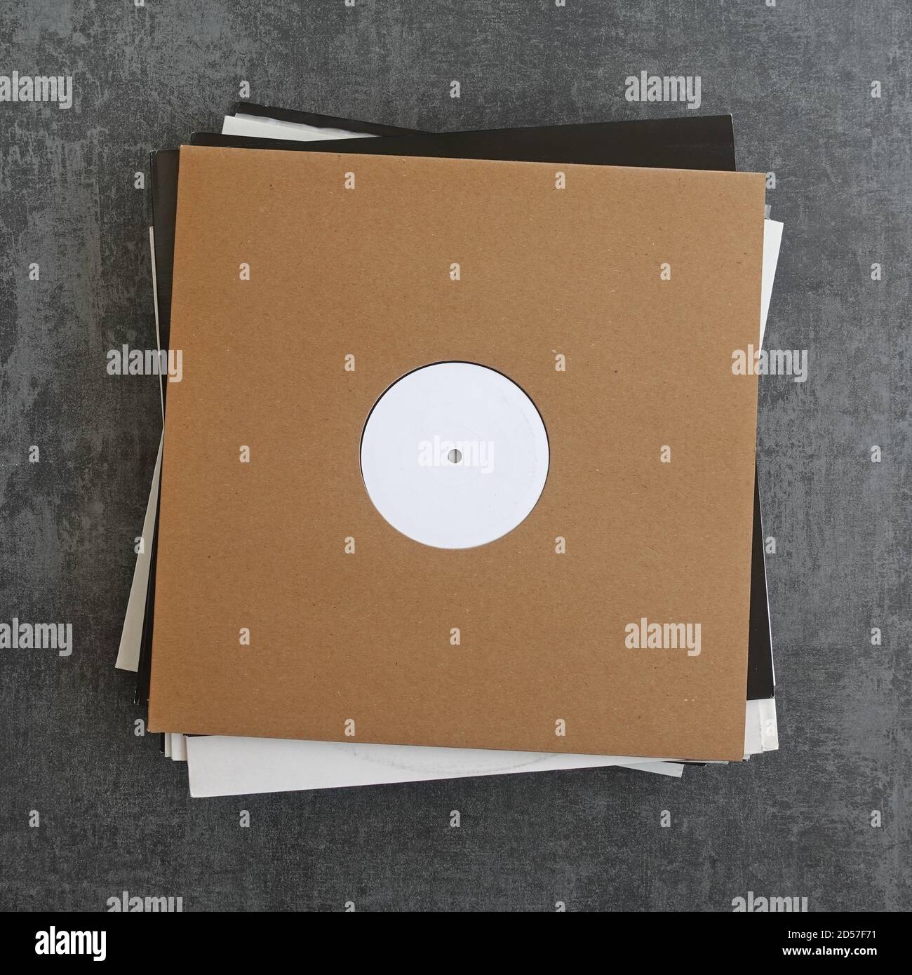 Pile of promo vinyl records in cardboard sleeves. Placer your logo or ...