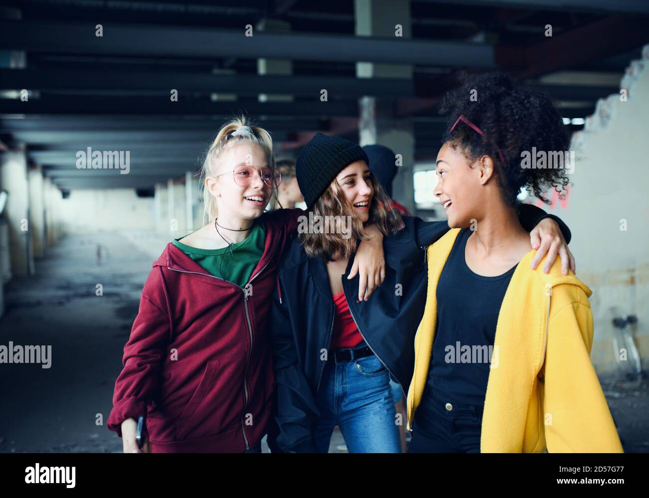 Group of teenagers girl gang standing indoors in abandoned building ...