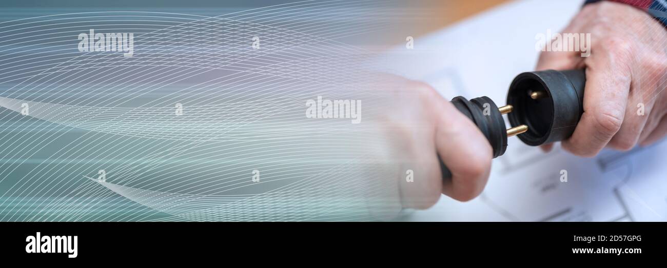 Electrician hands holding electrical plugs; panoramic banner Stock ...