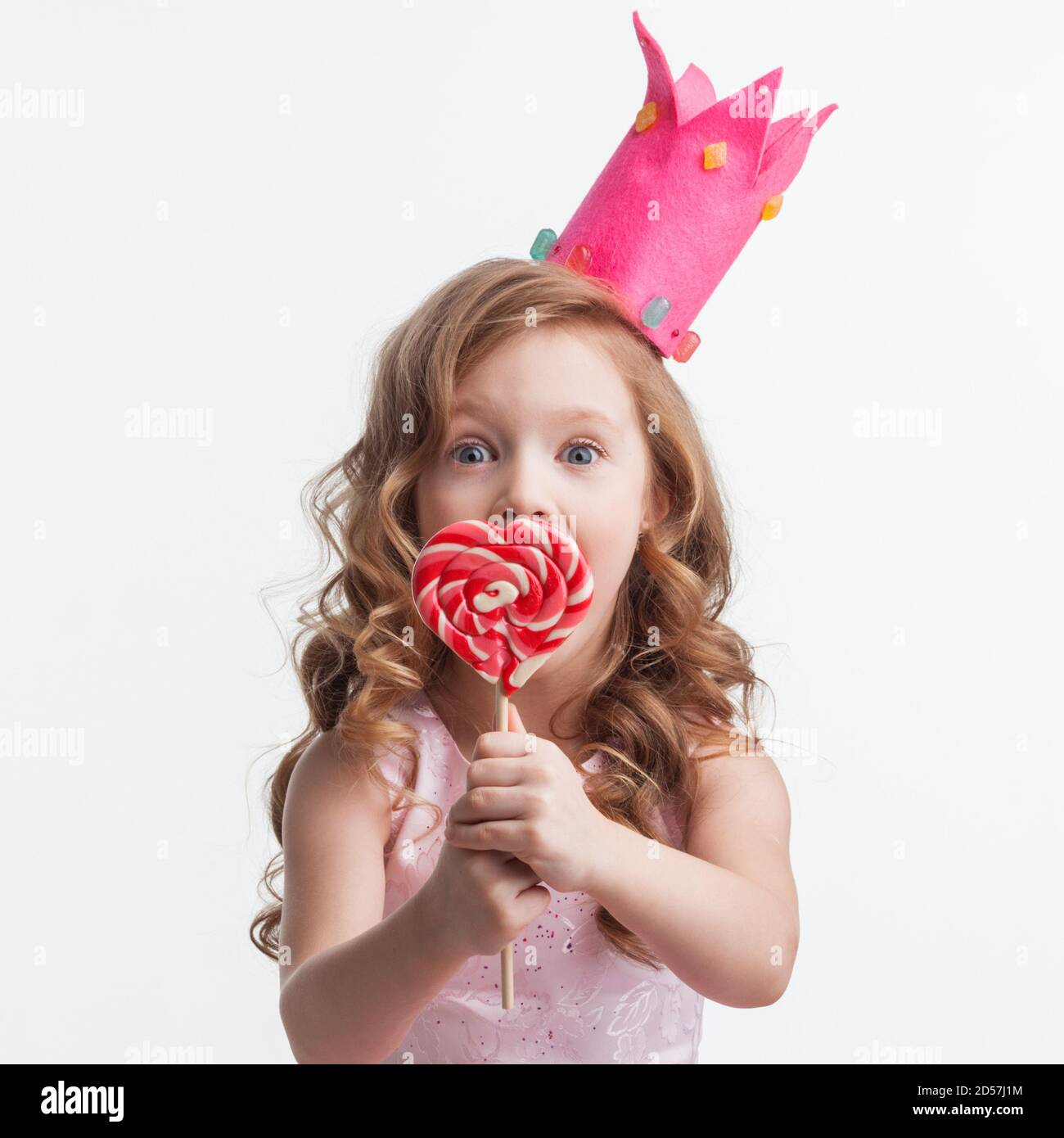 Beautiful little candy princess girl in crown with big pink heart ...