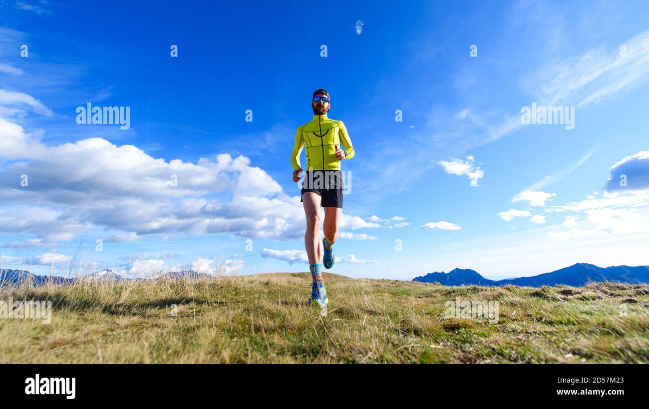 Running in the mountains between heaven and earth Stock Photo - Alamy