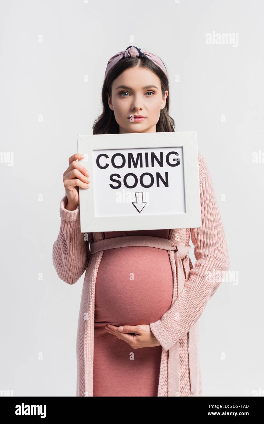 pregnant woman holding board with coming soon lettering isolated on ...