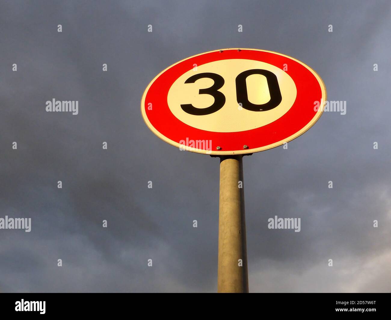 traffic sign in Germany at a dark sky with speed limit 30 Stock Photo ...