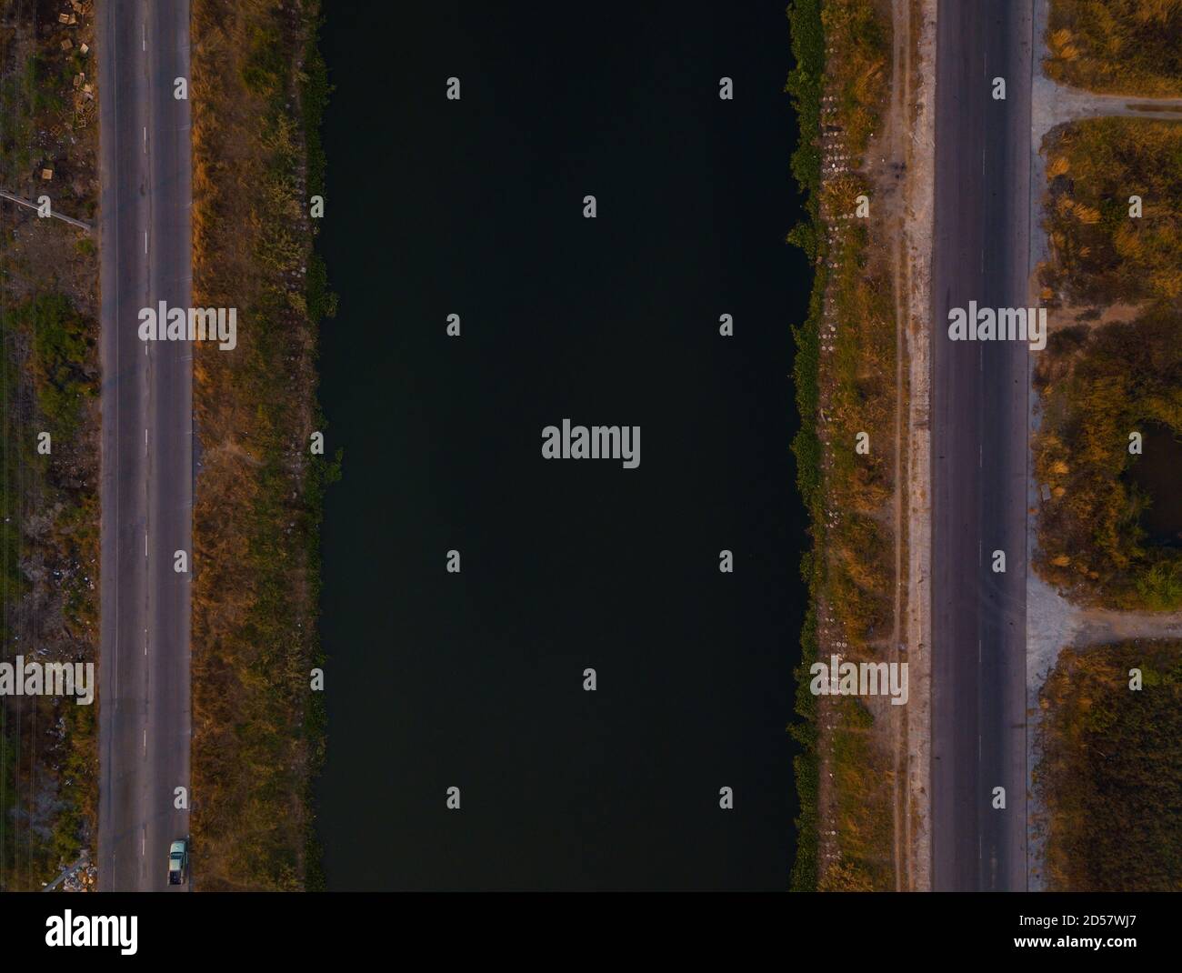 Aerial top view of one way road with canal for transportation ...