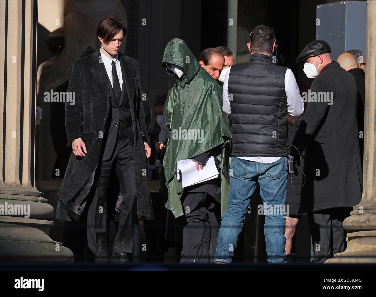Robert Pattinson (left) during the filming of The Batman taking place ...
