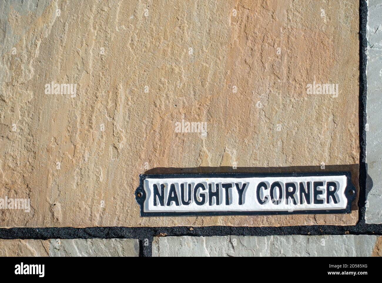 cast iron sign saying Naughty Corner Stock Photo - Alamy