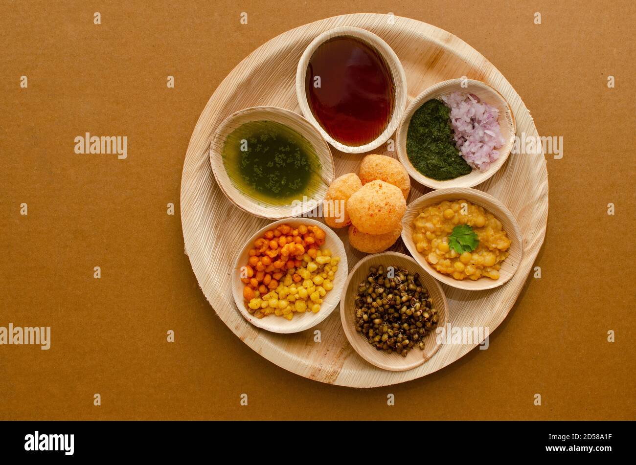 Nicely arranged Panipuri arranged in a circular shaped plate made of ...