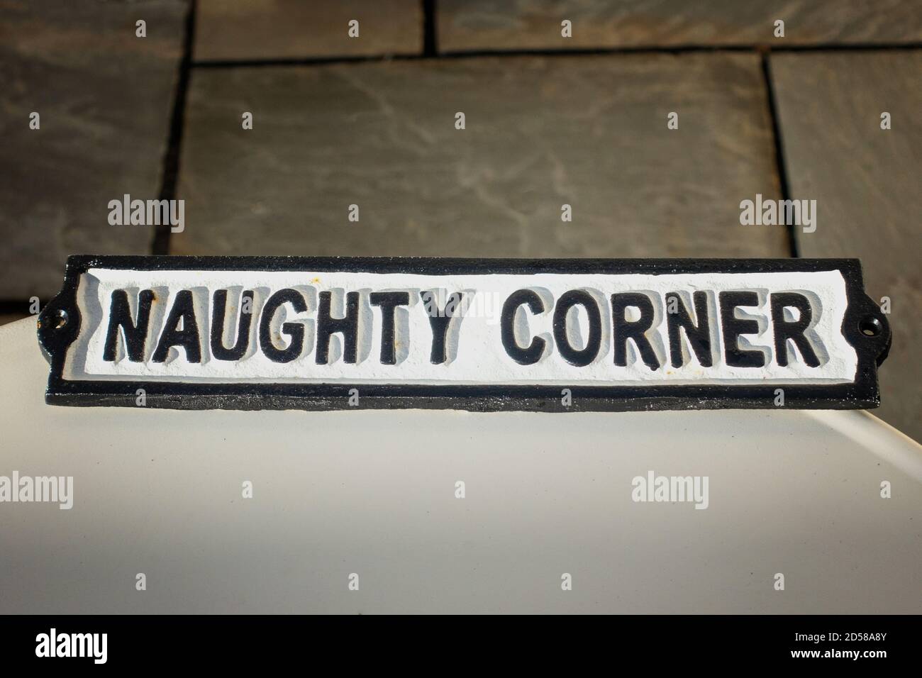 cast iron sign saying Naughty Corner Stock Photo - Alamy