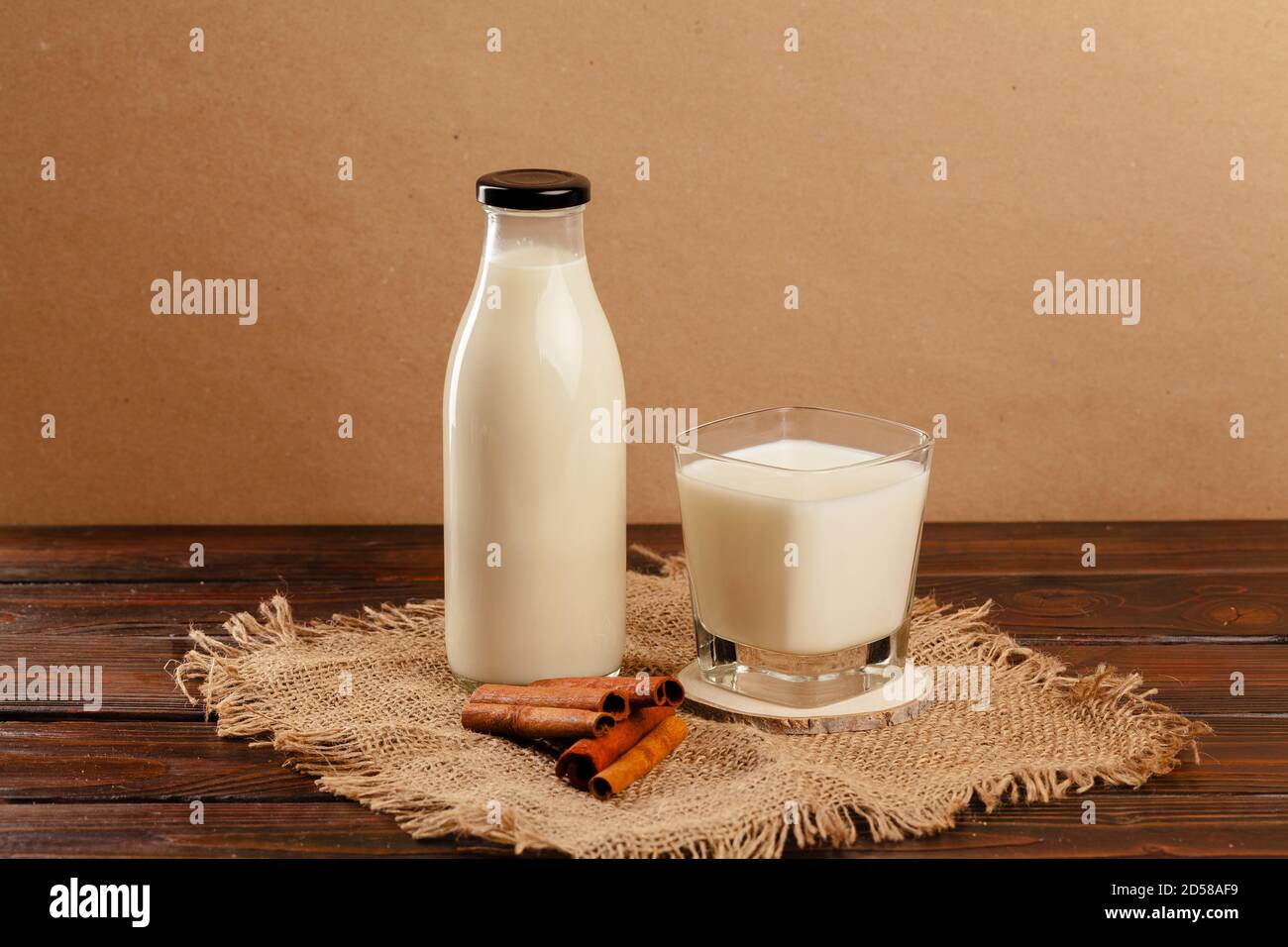 Glass bottle and glass cup with milk front view Stock Photo - Alamy