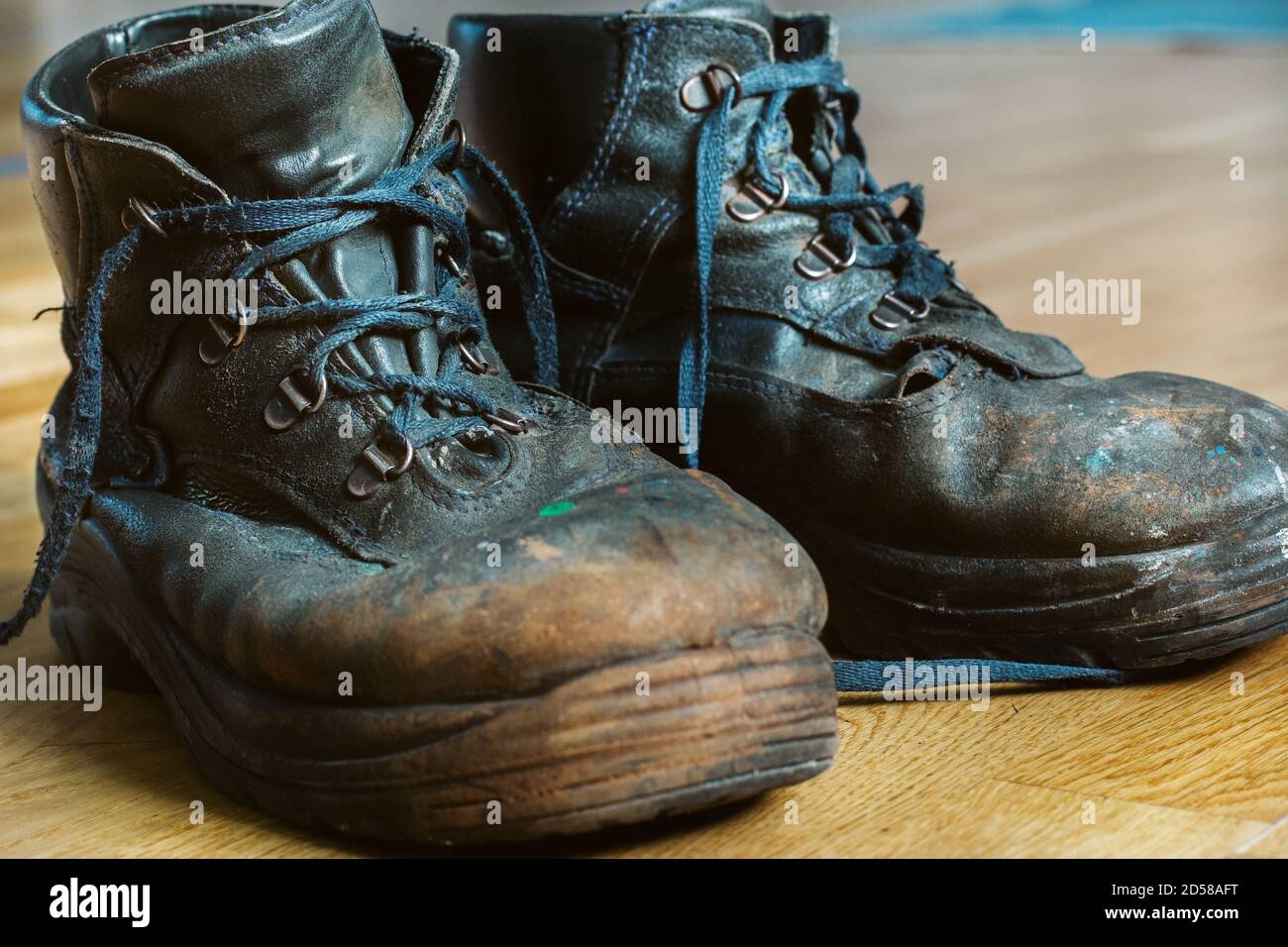 Old worn-out workman's shoes. Shoes that require repair or replacement ...