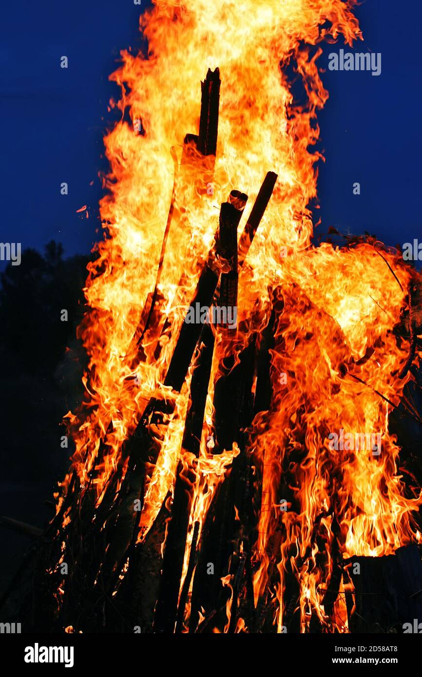Bright bonfire flame on the rural field at evening Stock Photo - Alamy