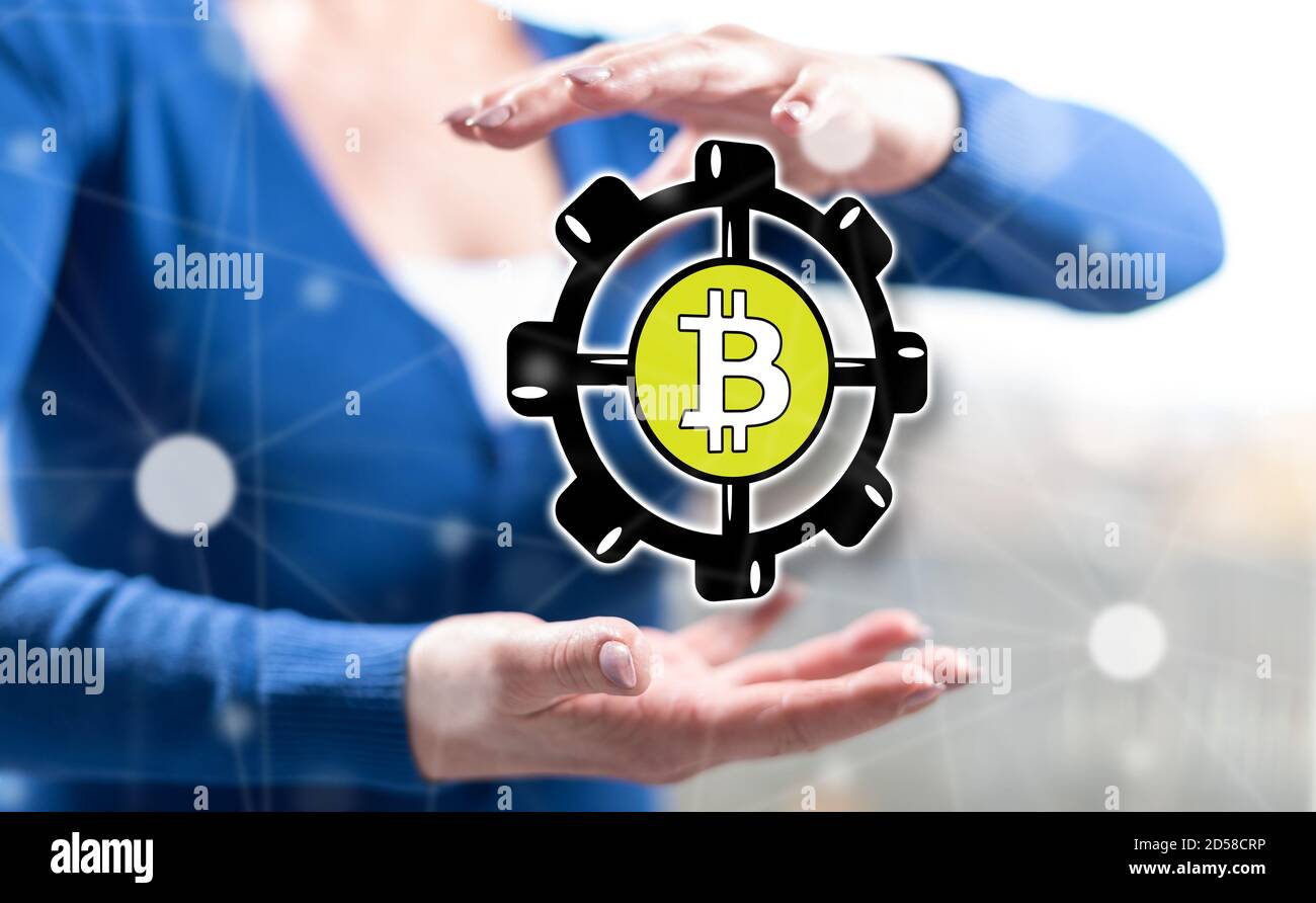 Bitcoin development concept between hands of a woman in background ...