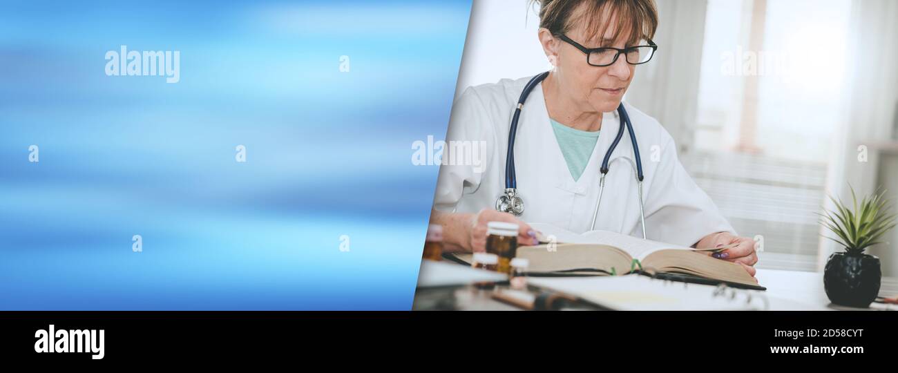 Female doctor reading a textbook in medical office; panoramic banner ...