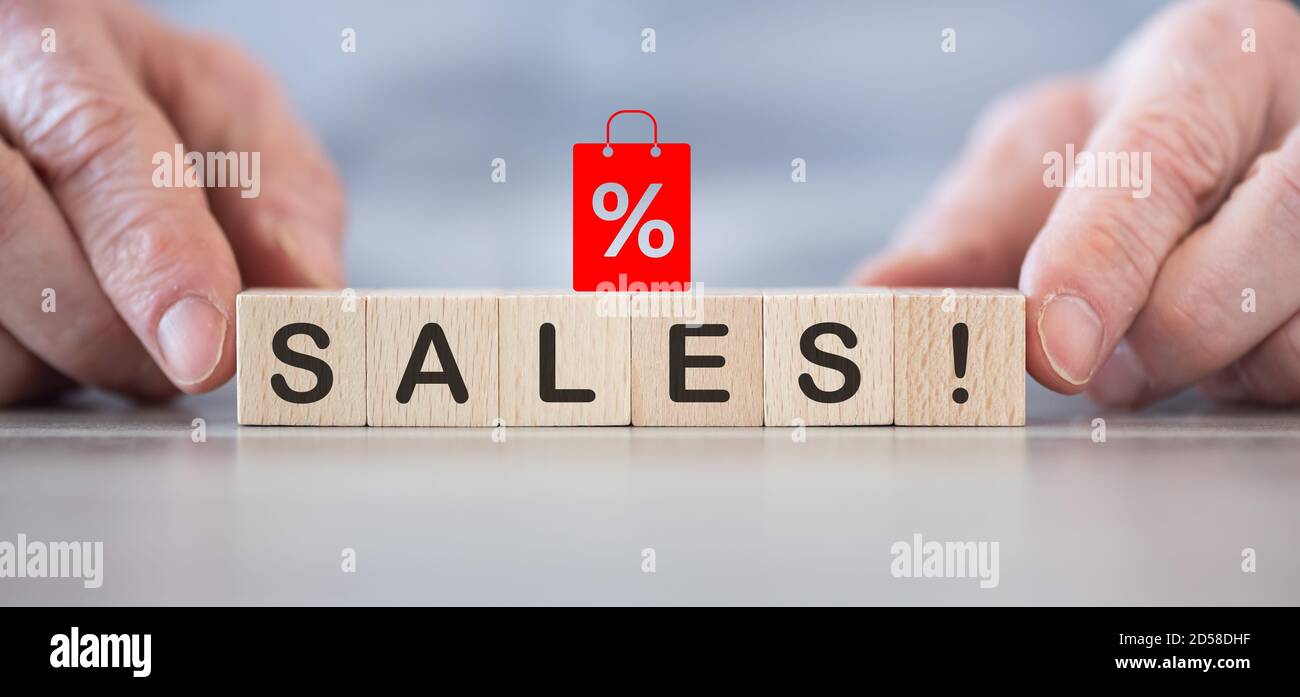 Concept of sales with wooden cubes Stock Photo - Alamy