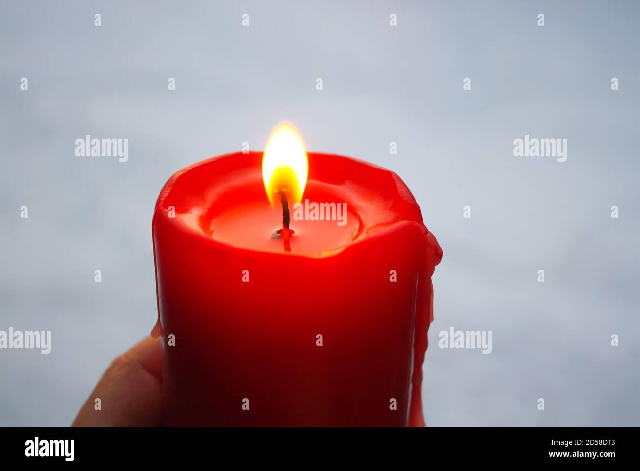 Red candle flame on fresh snow background Stock Photo - Alamy