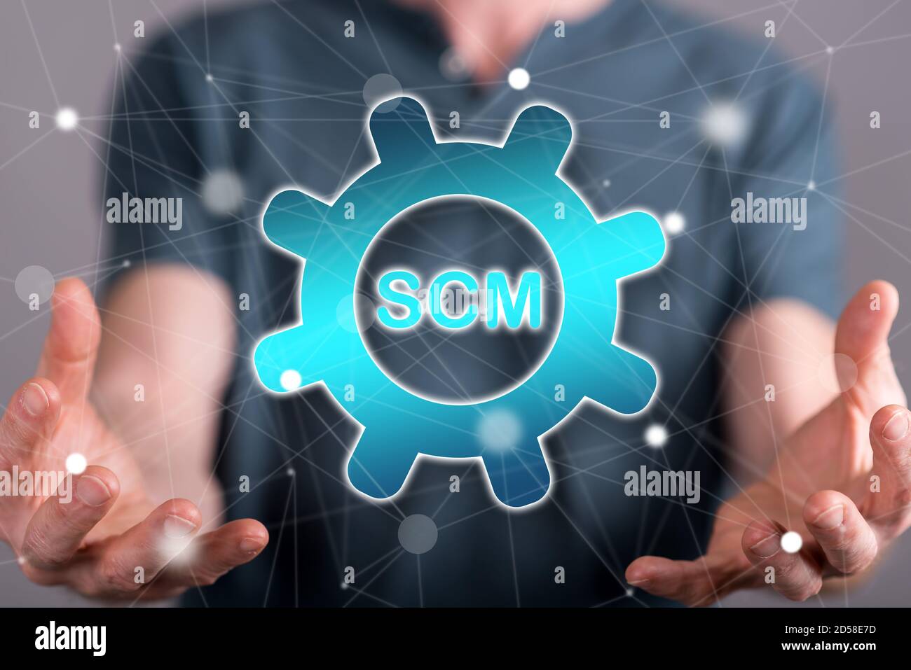 Scm concept between hands of a man in background Stock Photo - Alamy