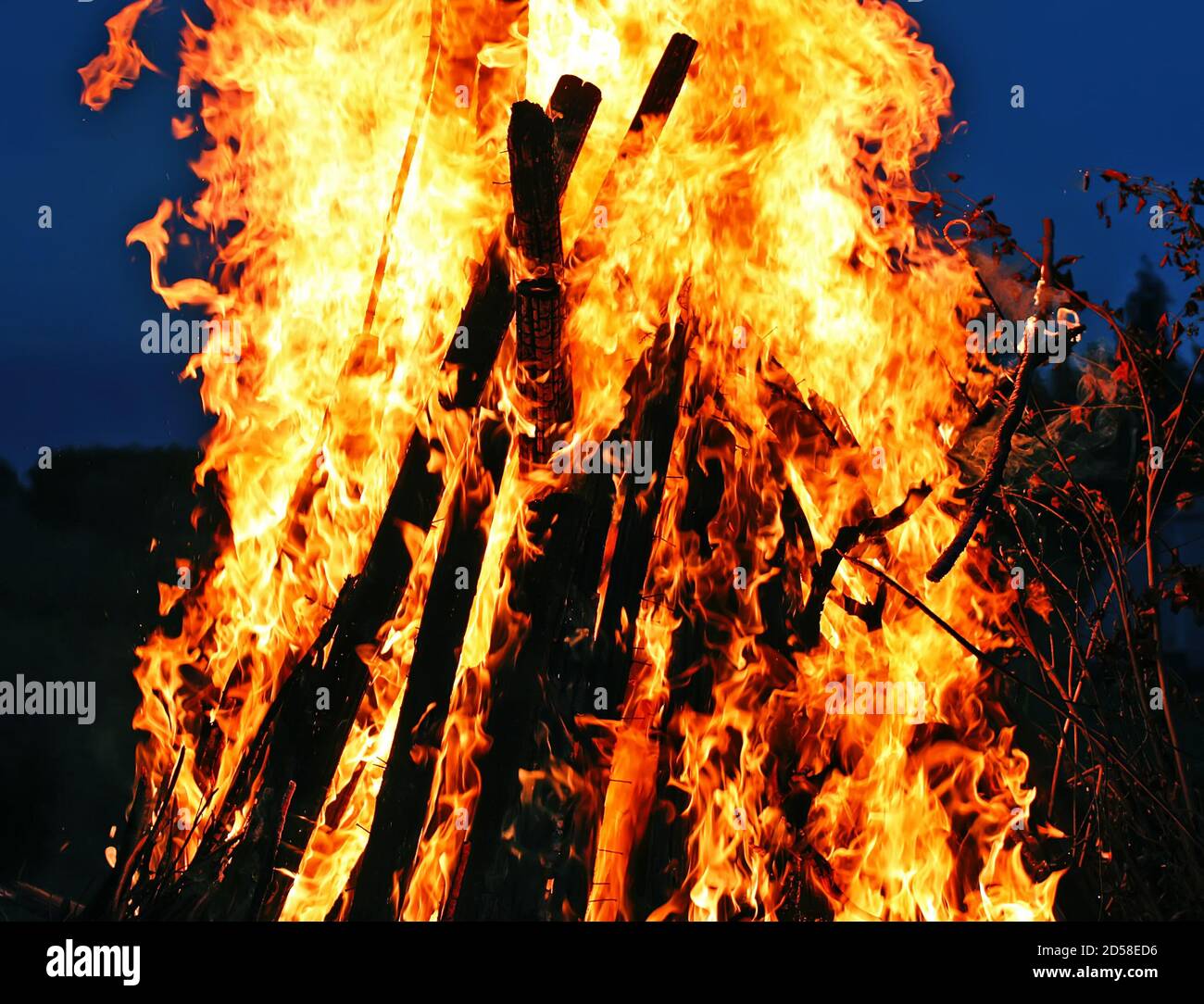 Bright bonfire flame on the rural field at evening Stock Photo - Alamy