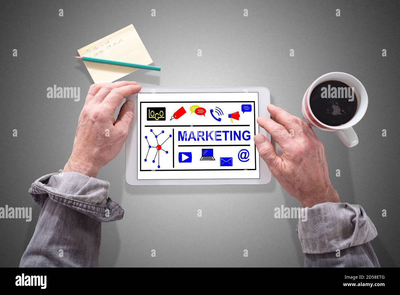Male hands using a tablet showing marketing concept Stock Photo - Alamy