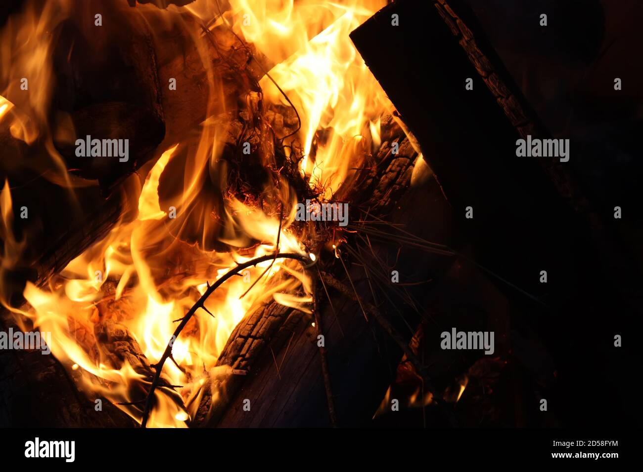 Bright flame of a burning fire above the brazier outdoors Stock Photo ...