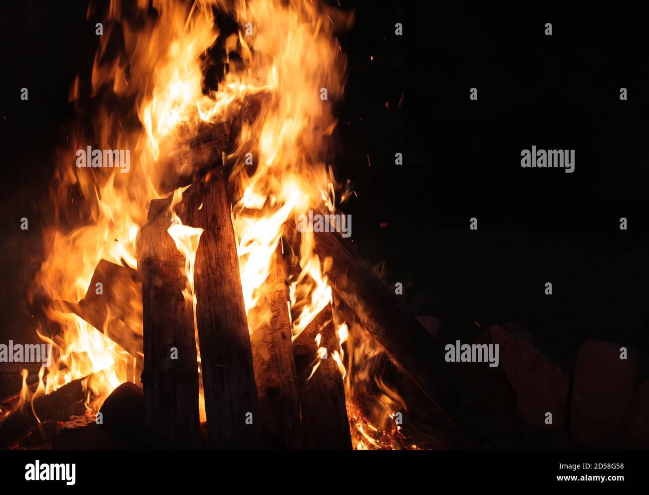 Bright flame of a burning fire above the brazier outdoors Stock Photo ...