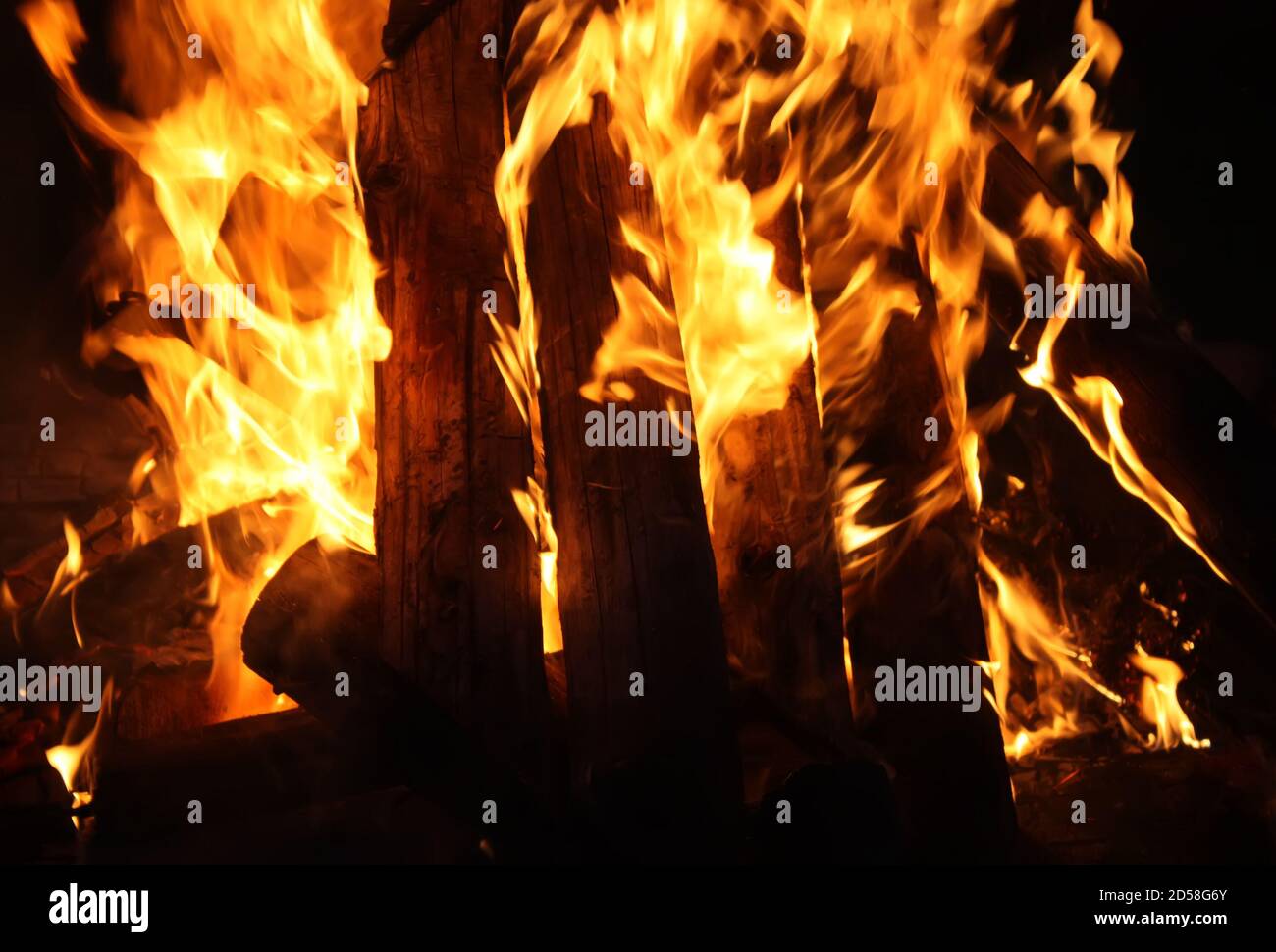 Bright flame of a burning fire above the brazier outdoors Stock Photo ...