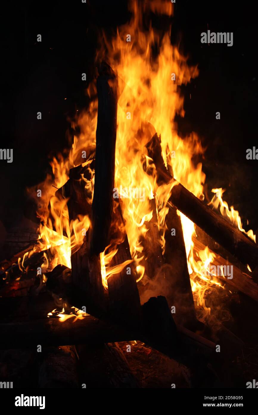 Bright flame of a burning fire above the brazier outdoors Stock Photo ...