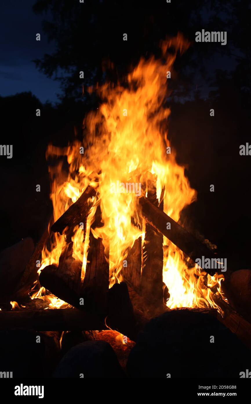Bright flame of a burning fire above the brazier outdoors Stock Photo ...