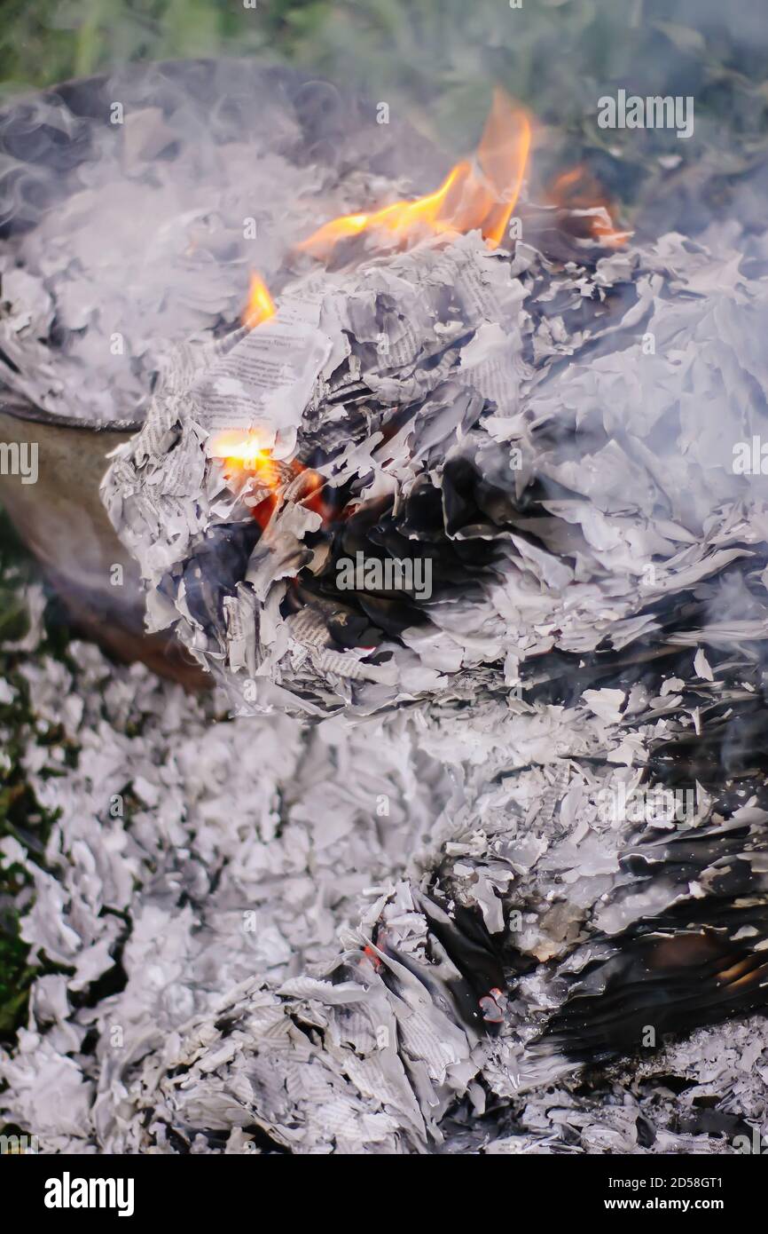Paper burning on green summer grass outdoors Stock Photo - Alamy