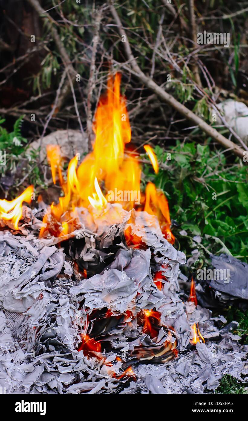 Paper burning on green summer grass outdoors Stock Photo - Alamy