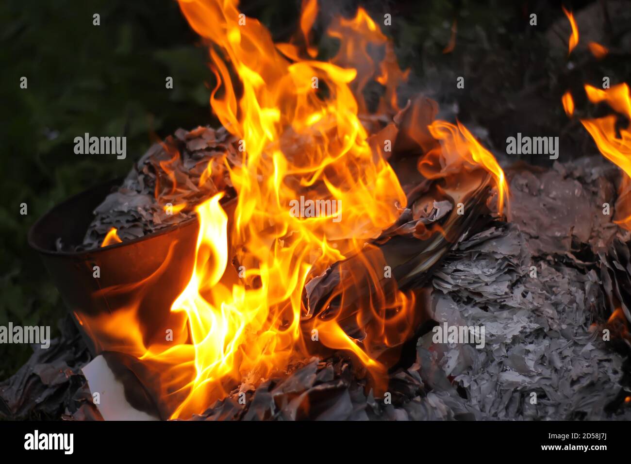 Paper burning on green summer grass outdoors Stock Photo - Alamy
