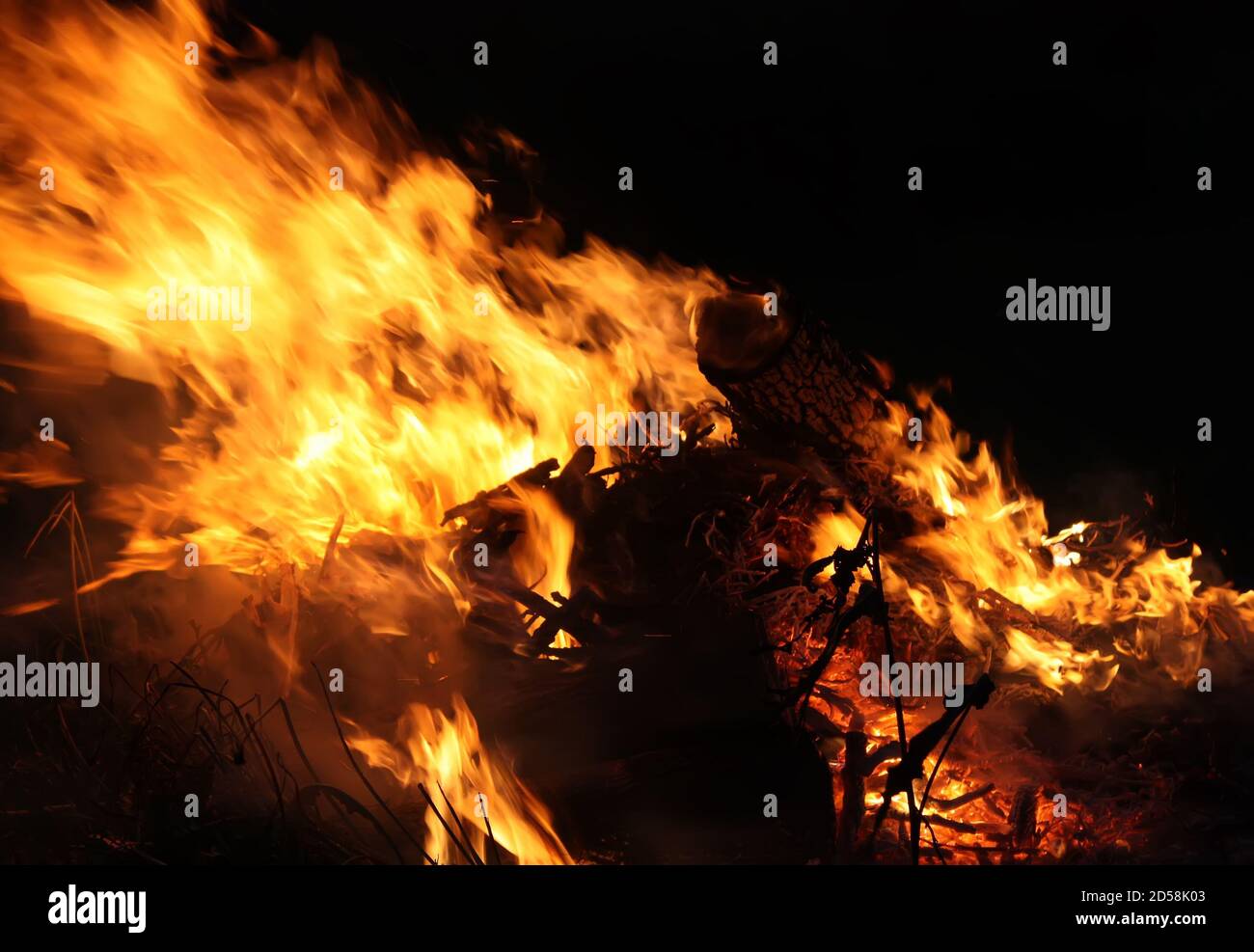 Bright flame of a burning fire above the brazier outdoors Stock Photo ...