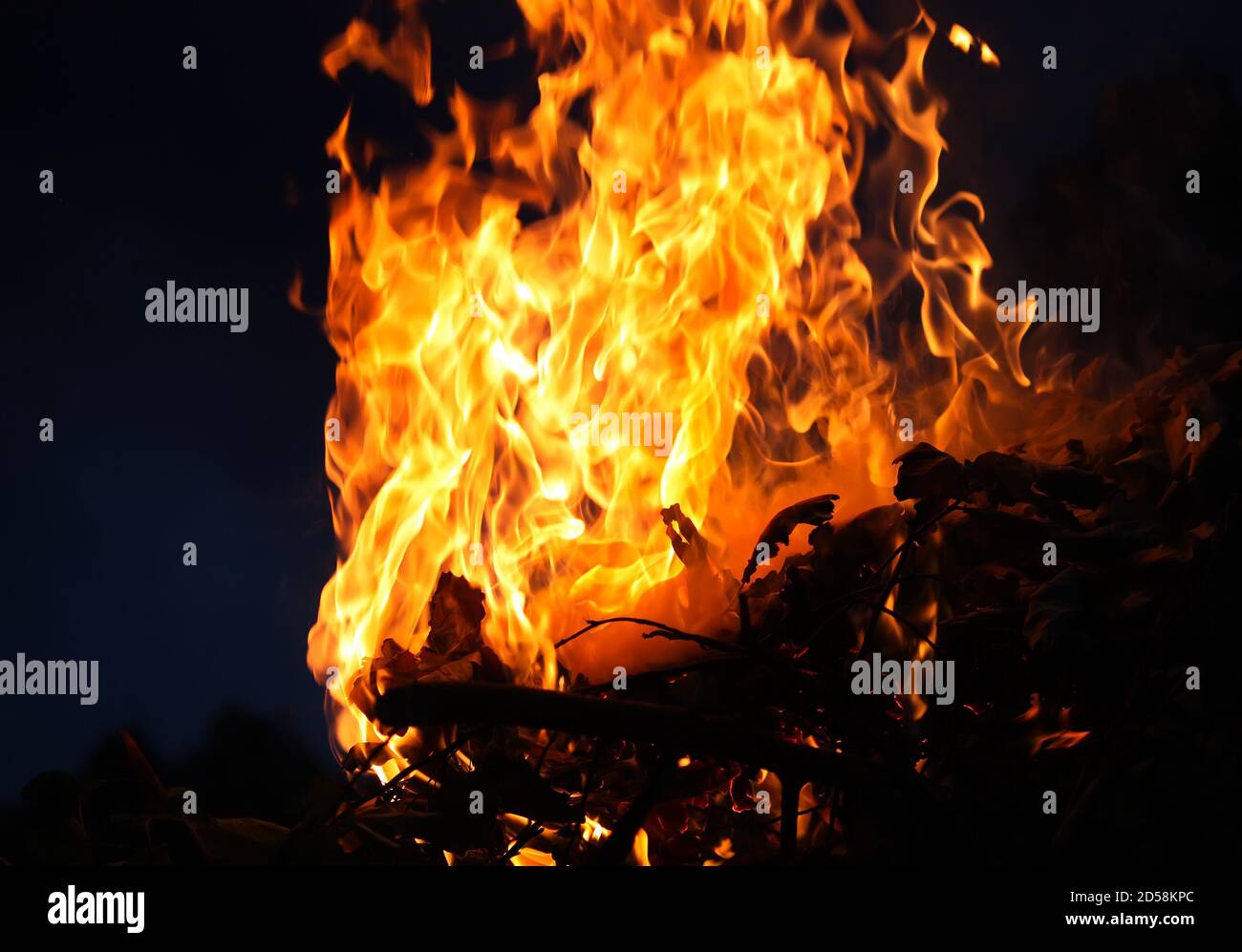 Bright flame of a burning fire above the brazier outdoors Stock Photo ...
