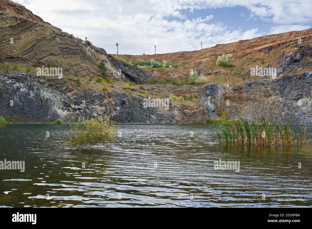 Landscape with a lake formed in an ancient quarry with sedimentary ...