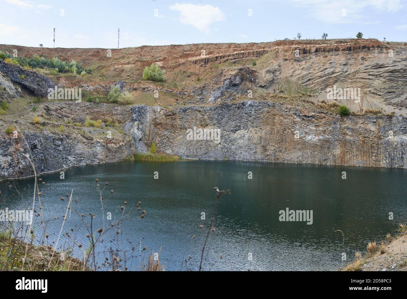 Landscape with a lake formed in an ancient quarry with sedimentary ...