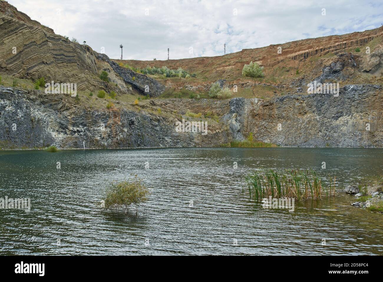 Landscape with a lake formed in an ancient quarry with sedimentary ...