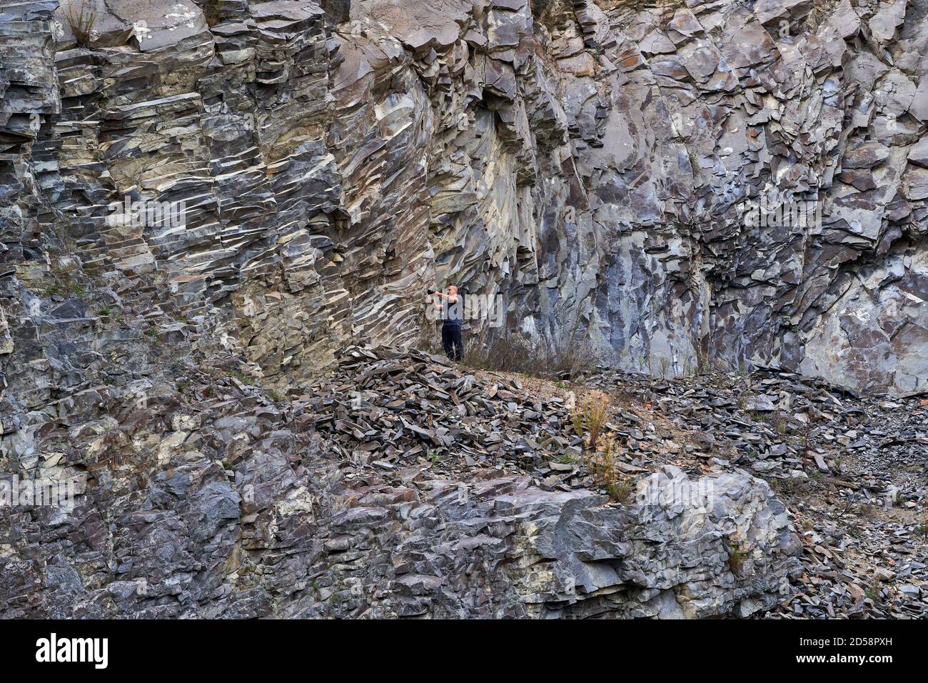 Professional photographer documenting various rock types in an ...