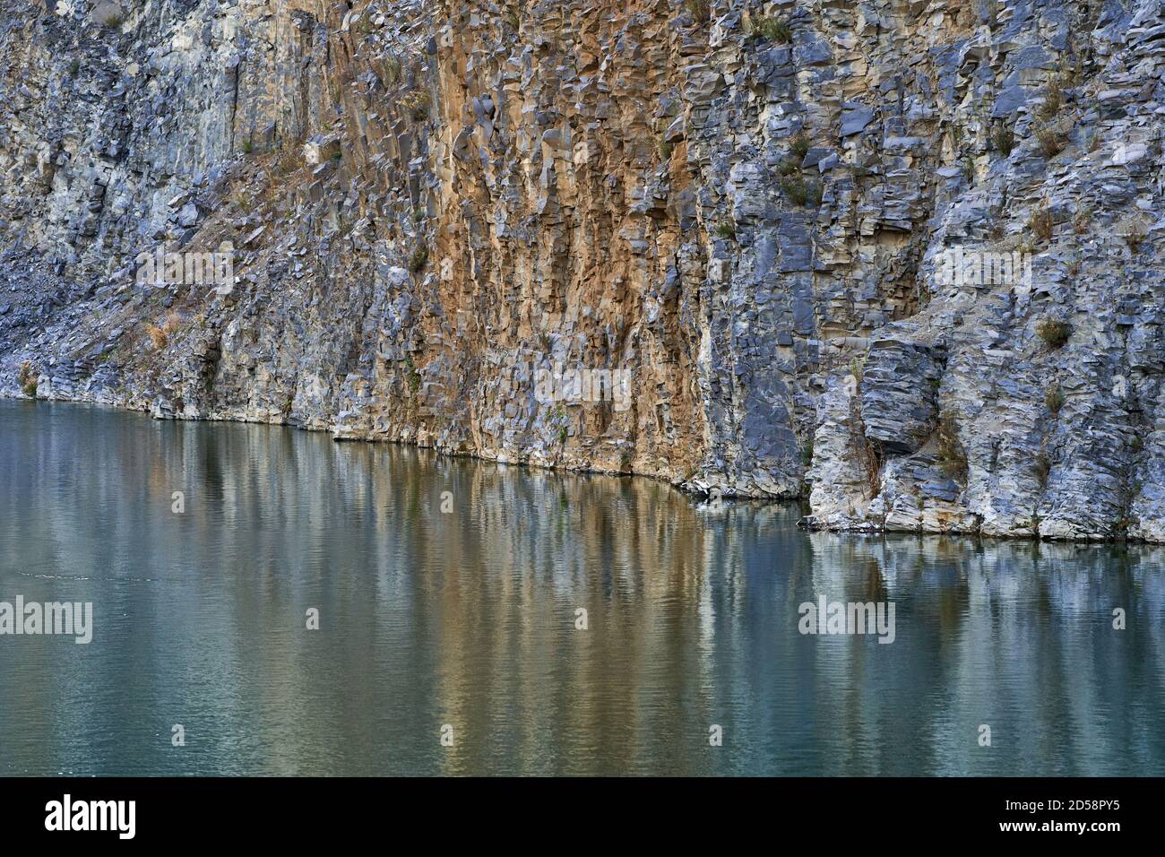Landscape with a lake formed in an ancient quarry with sedimentary ...