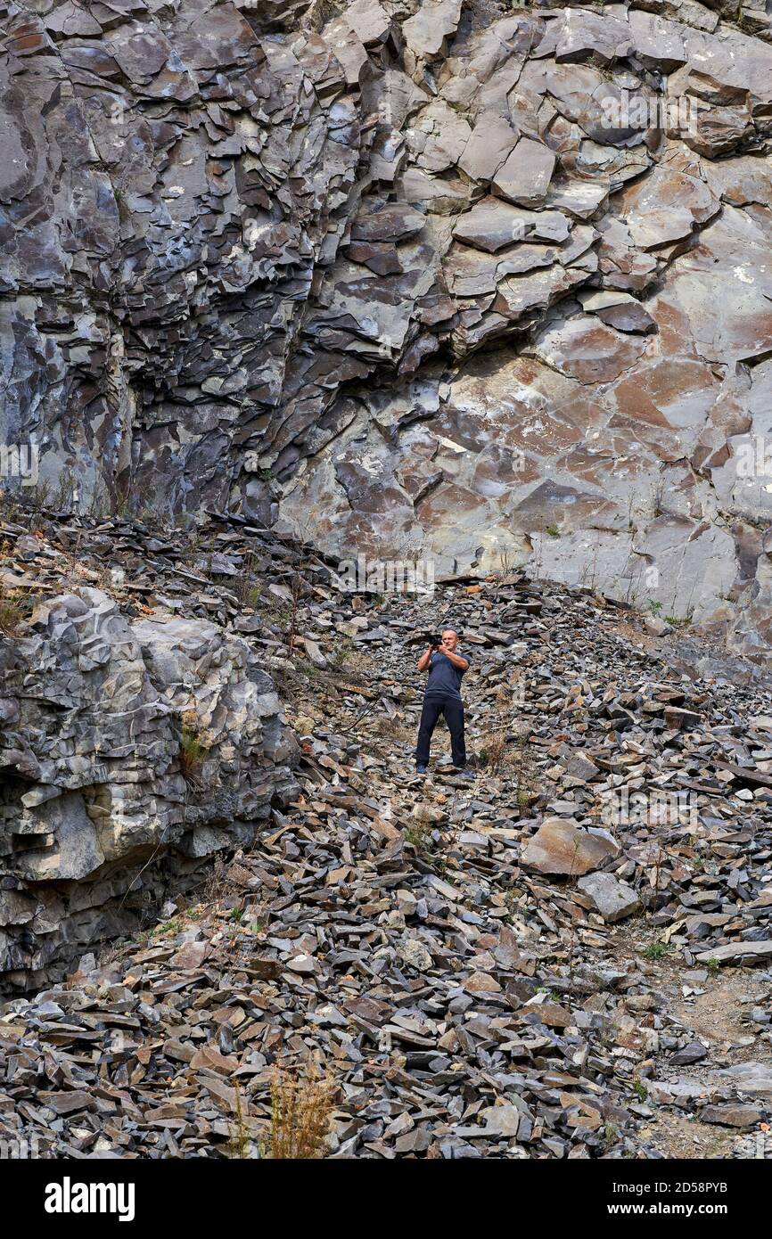 Professional photographer documenting various rock types in an ...