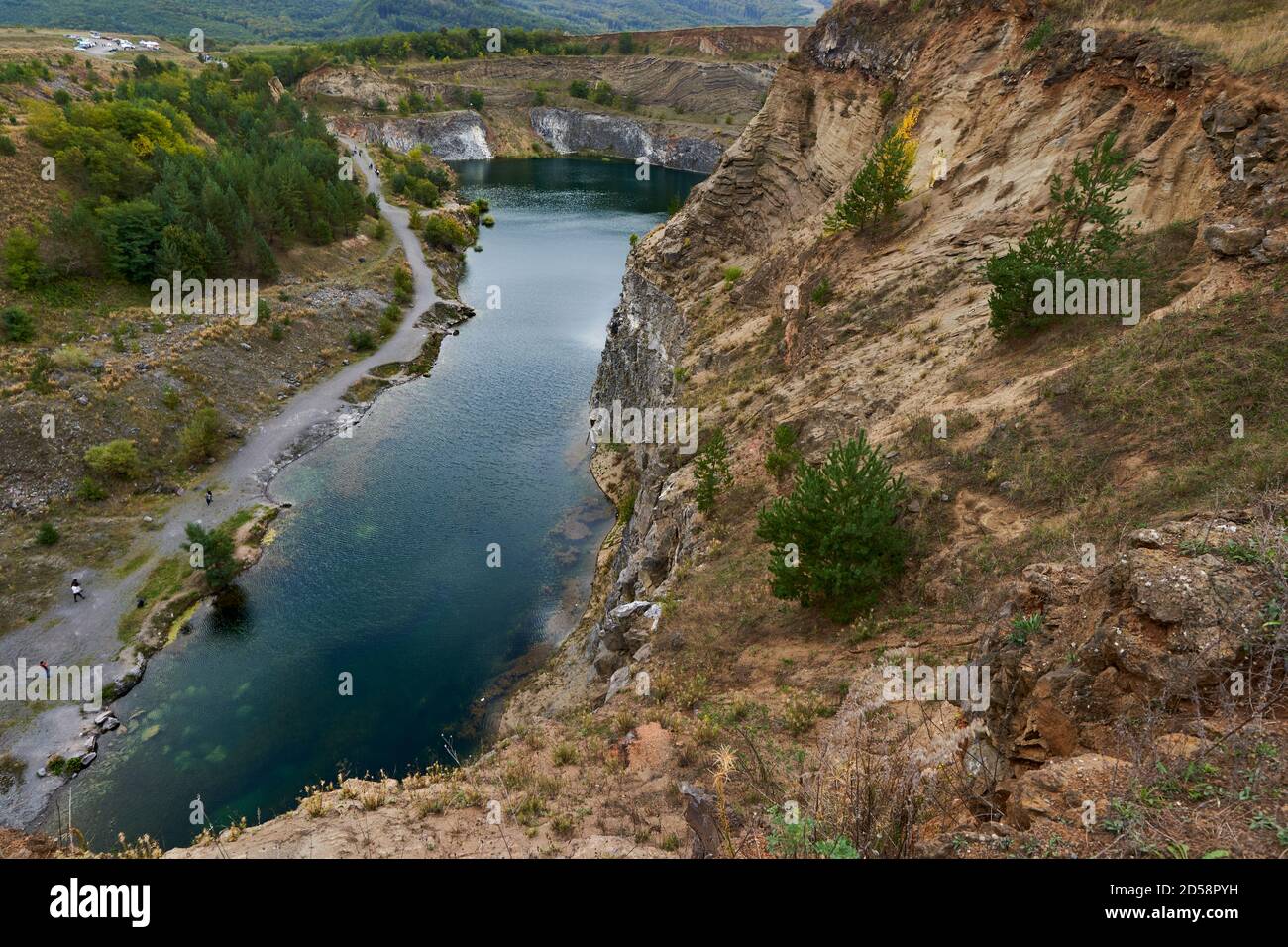 Landscape with a lake formed in an ancient quarry with sedimentary ...