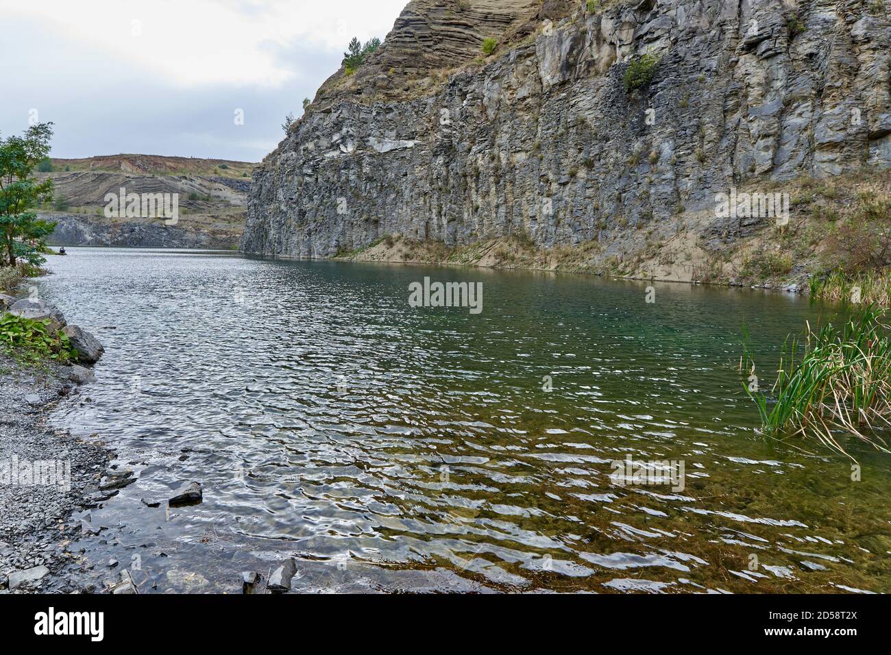 Landscape with a lake formed in an ancient quarry with sedimentary ...