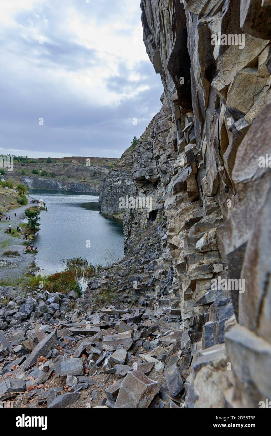 Landscape with a lake formed in an ancient quarry with sedimentary ...