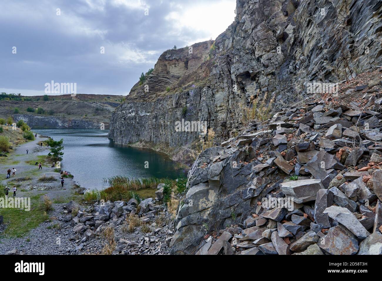 Landscape with a lake formed in an ancient quarry with sedimentary ...
