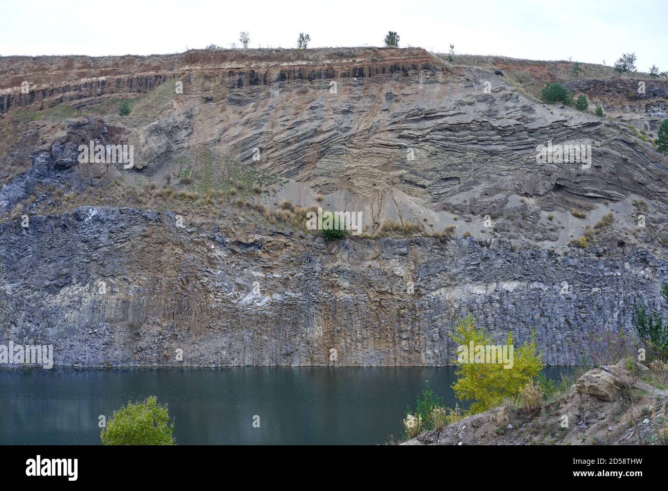 Landscape with a lake formed in an ancient quarry with sedimentary ...