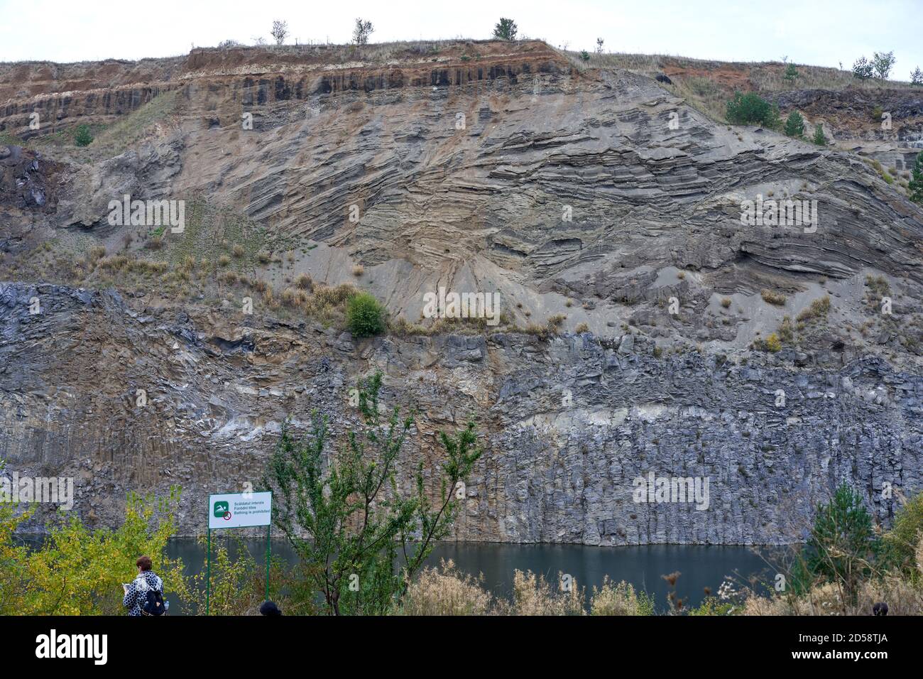 Landscape with a lake formed in an ancient quarry with sedimentary ...