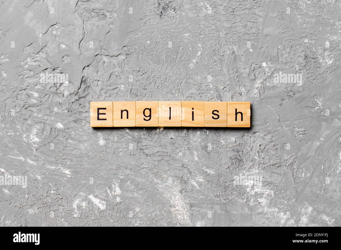 english word written on wood block. english text on cement table for ...