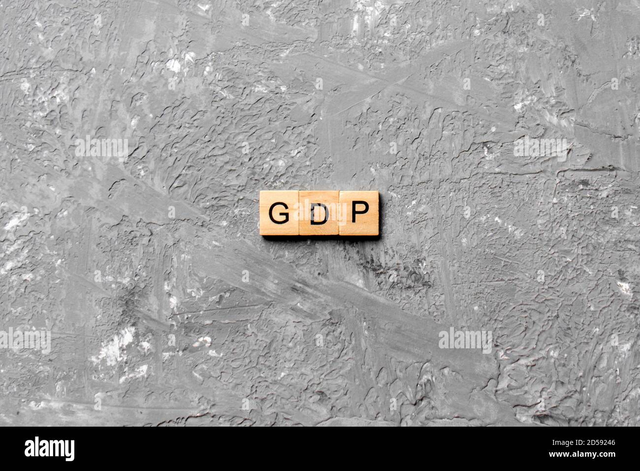 GDP word written on wood block. gross domestic product text on cement ...