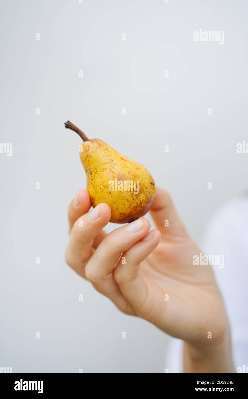 Hand holding pear hi-res stock photography and images - Alamy