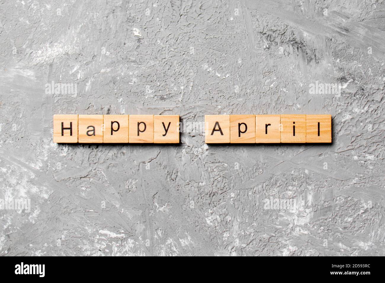 Happy april word written on wood block. Happy april text on table ...