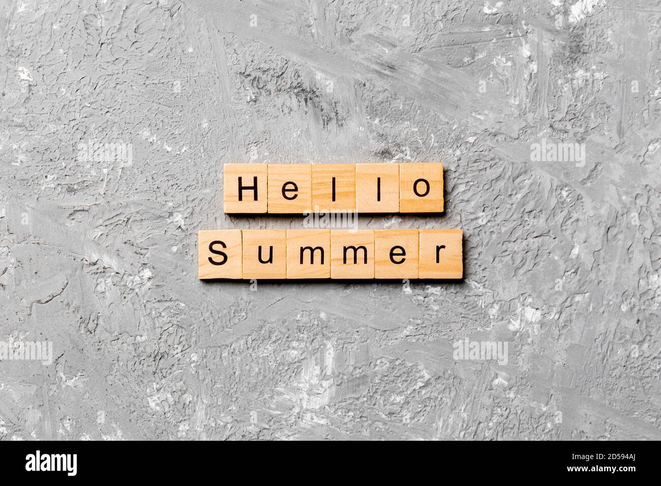 Hello Summer word written on wood block. Hello Summer text on cement ...