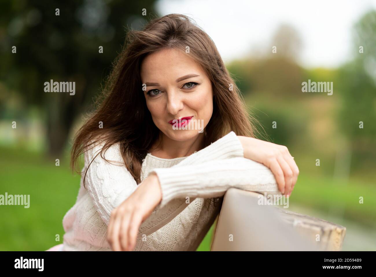 Girl on a park bench hi-res stock photography and images - Alamy